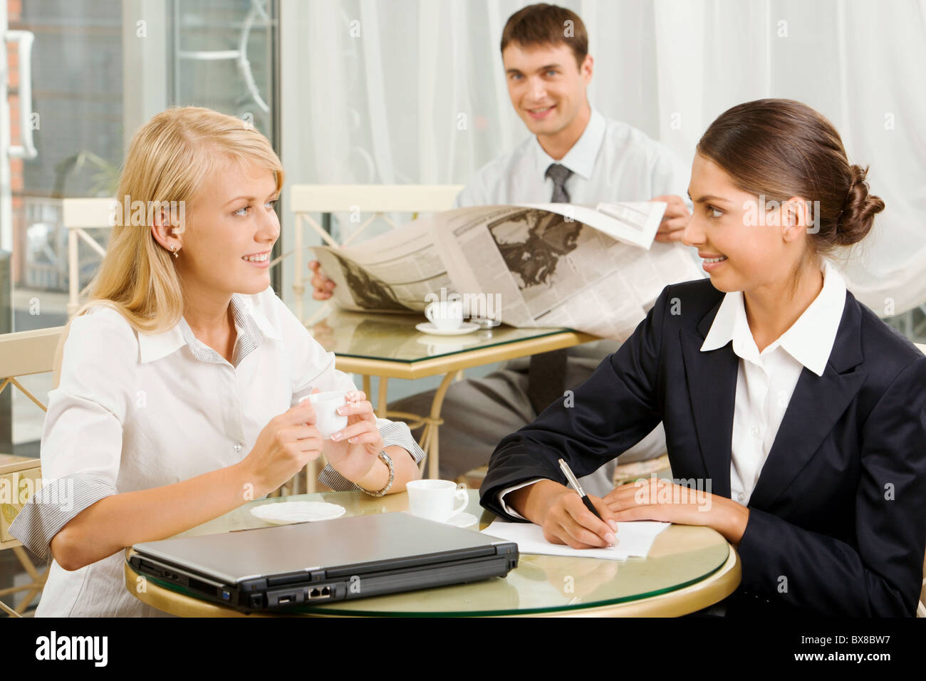 Portrait of two business women talking in the cafe Stock Photo - Alamy
