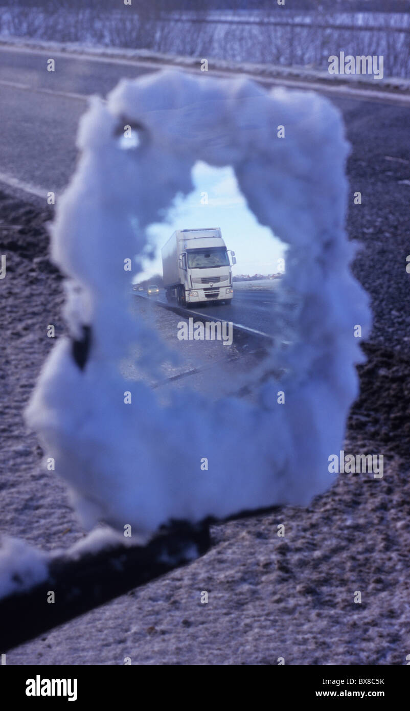 lorry reflected in vehicle wing mirror covered in frozen snow and ice ...