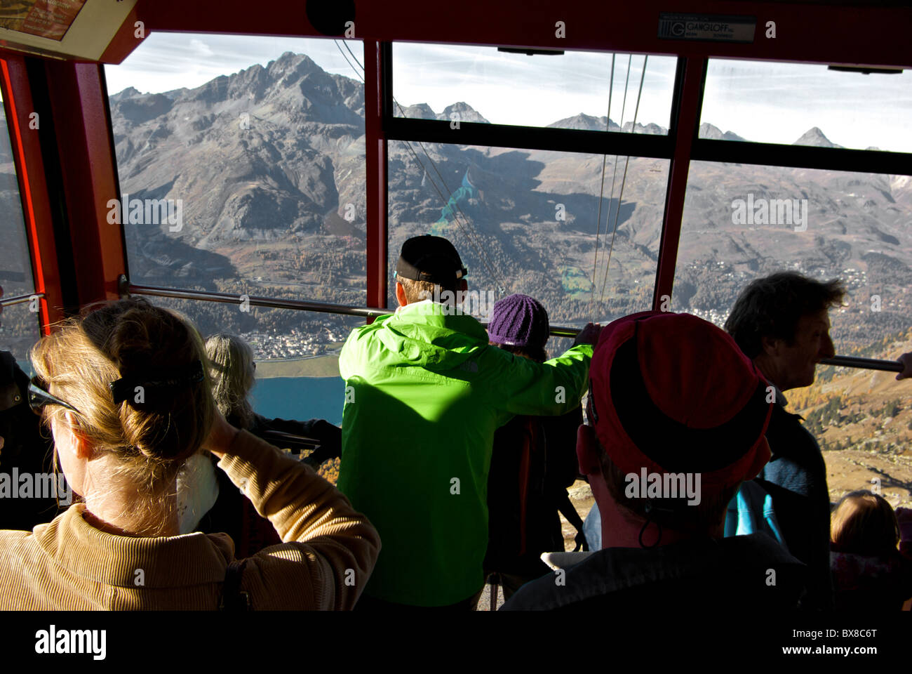 Passengers in aerial cable tram car descending Mount Corvatsch St ...