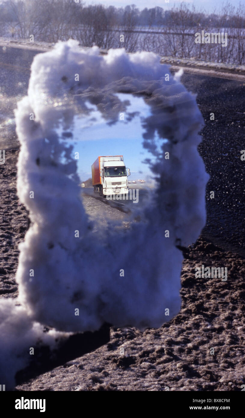 lorry reflected in vehicle wing mirror covered in frozen snow and ice ...