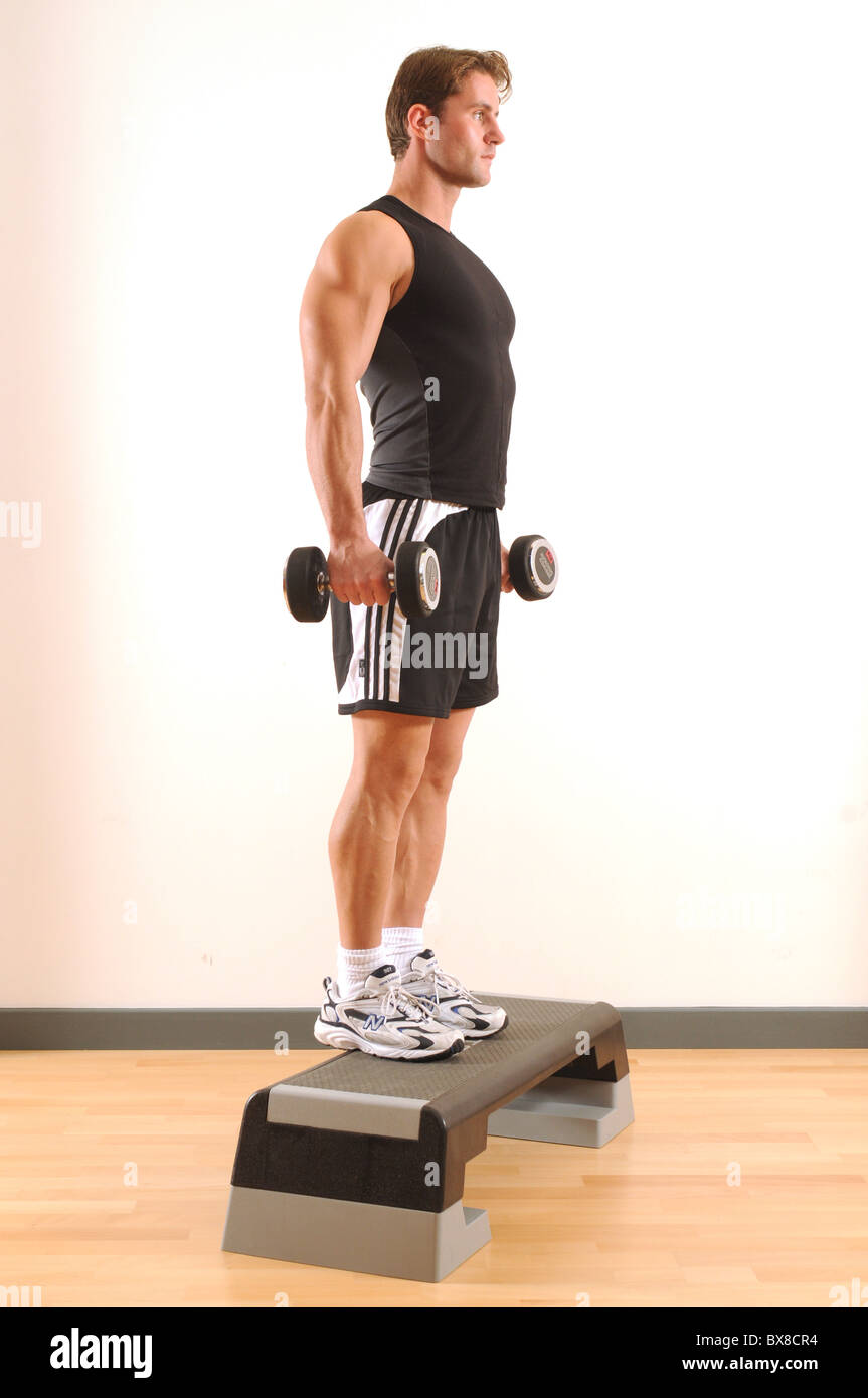 25-30 yr old male exercising in health club studio Stock Photo - Alamy