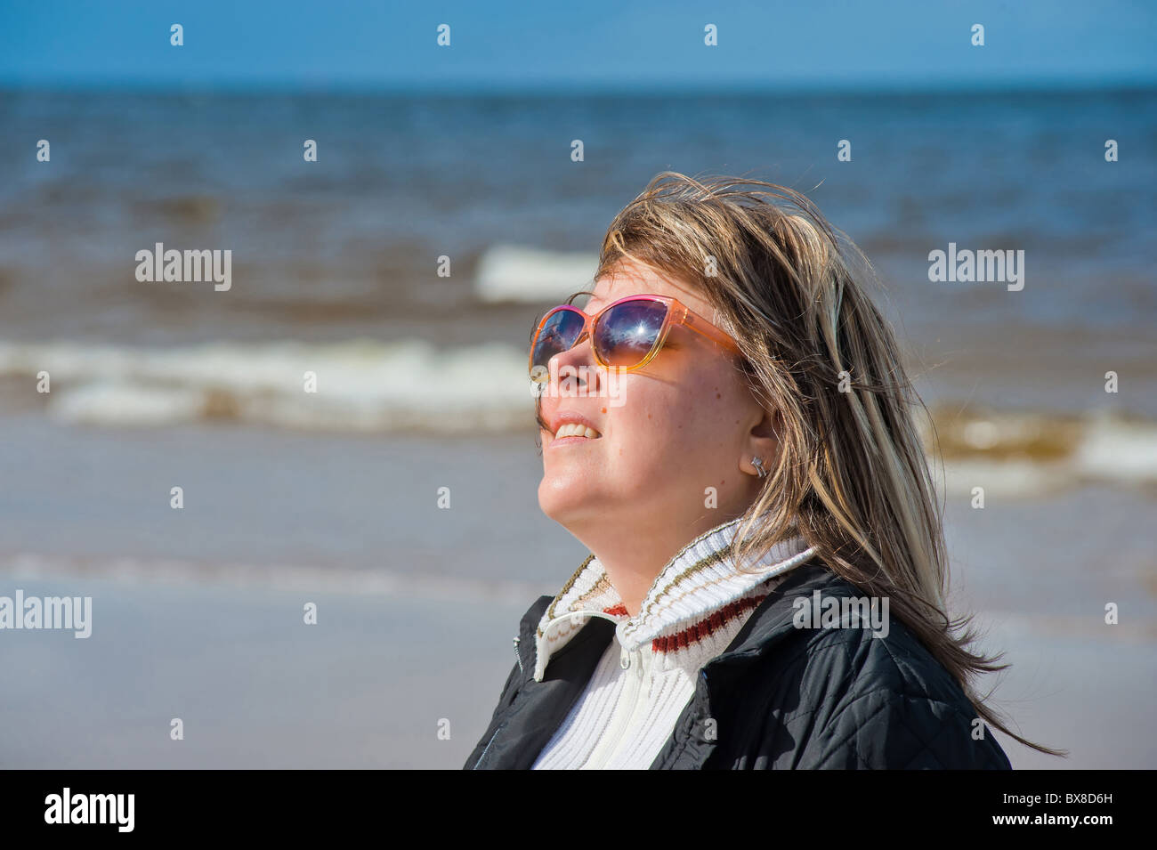 Portrait Of Mature Woman In Sunglasses Relaxing At The Baltic Sea In