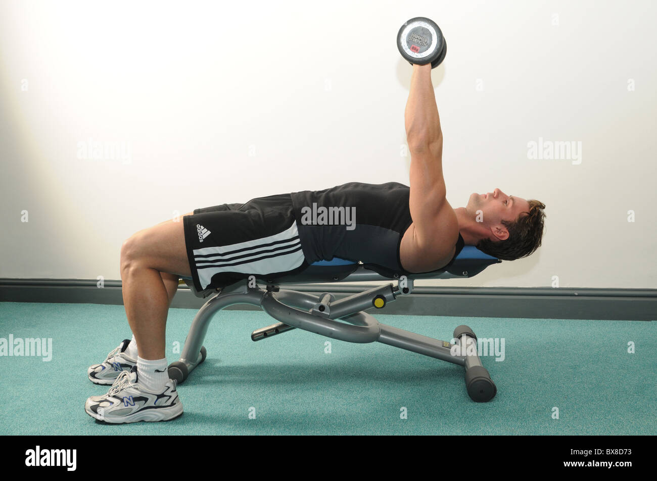 25-30 yr old male exercising in health club studio Stock Photo - Alamy