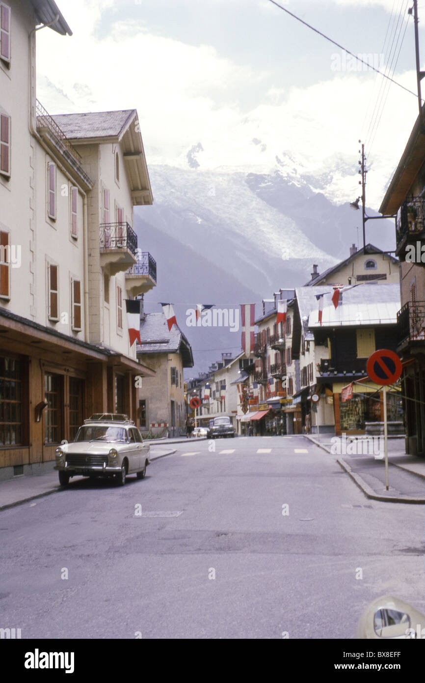 A 1964 street scene in Chamonix, France, showing cars, shops and Alpine ...