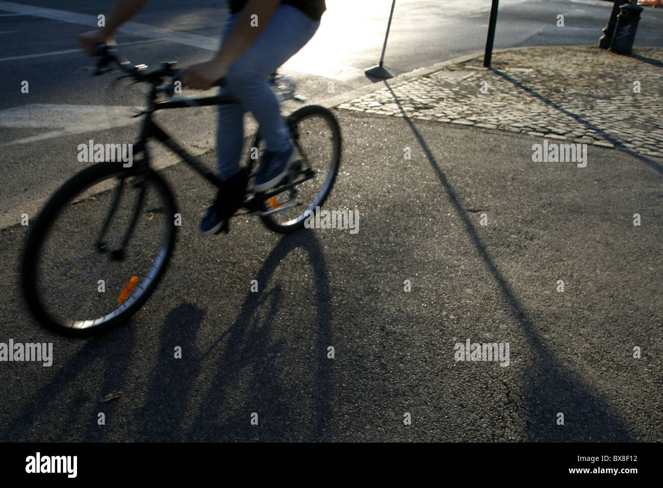 person riding bike in city town Stock Photo - Alamy