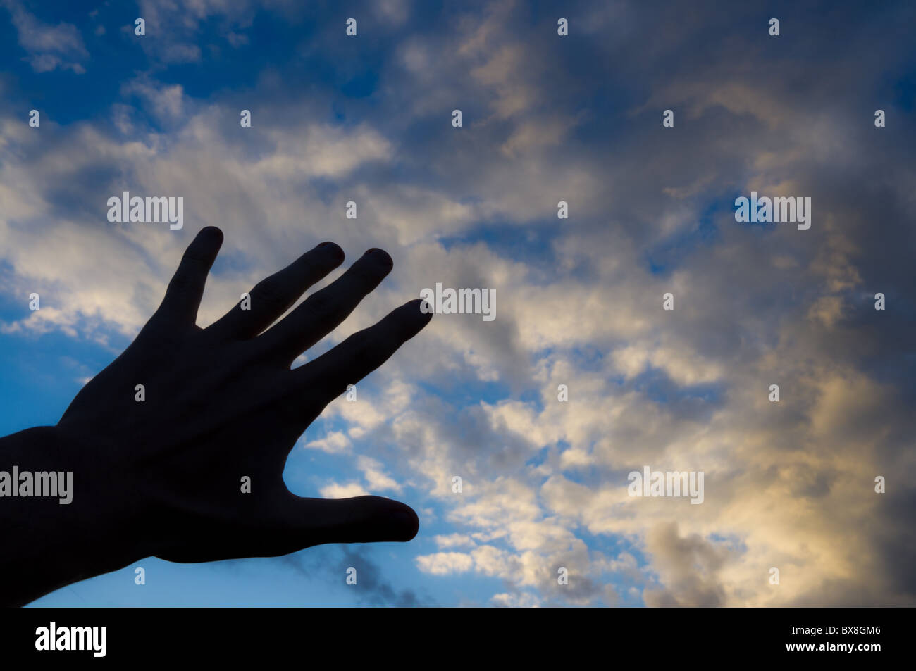 Silhouette hand reaching the sky Stock Photo - Alamy