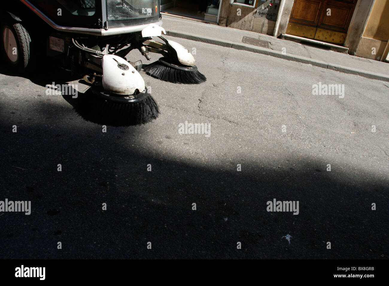 road cleaning machine brushes on street in rome italy Stock Photo - Alamy