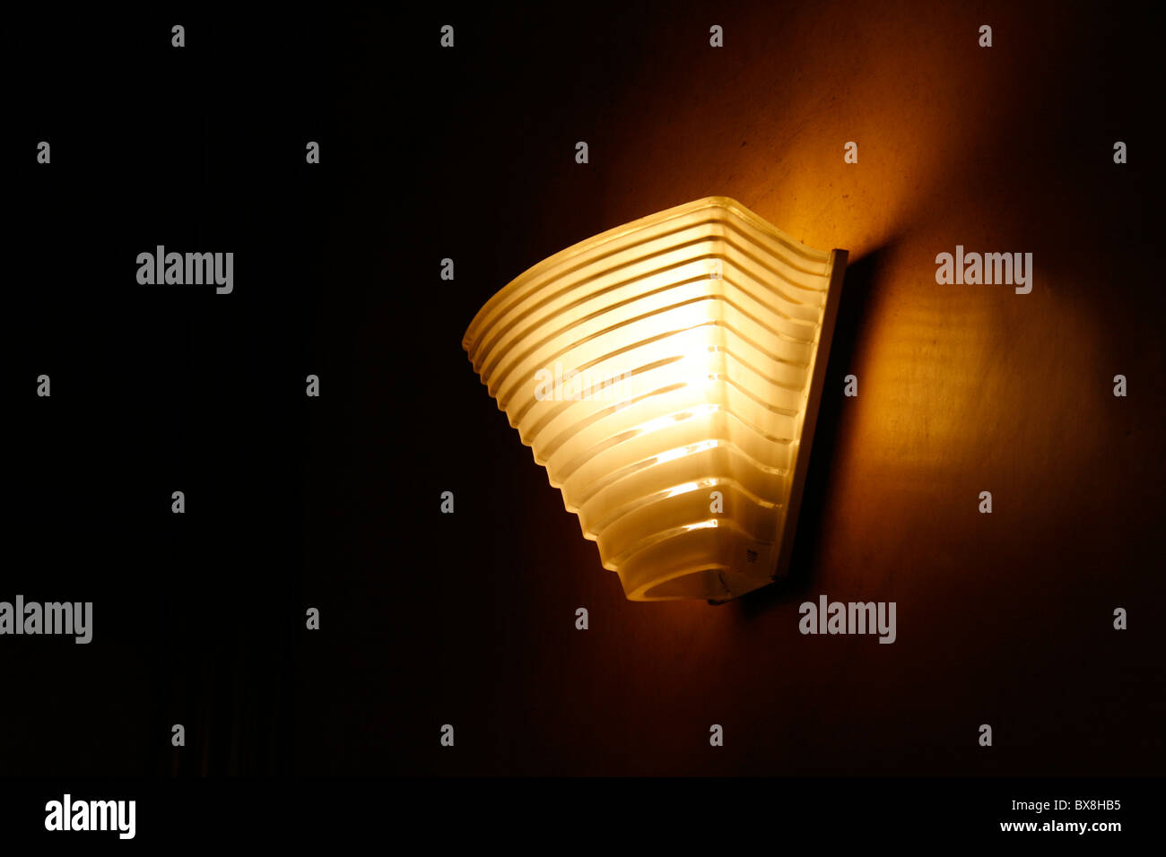 one wall lamp in dark setting indoors Stock Photo - Alamy