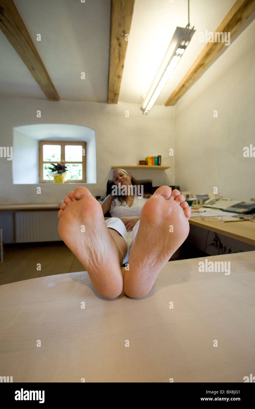Woman Feet Up On Desk