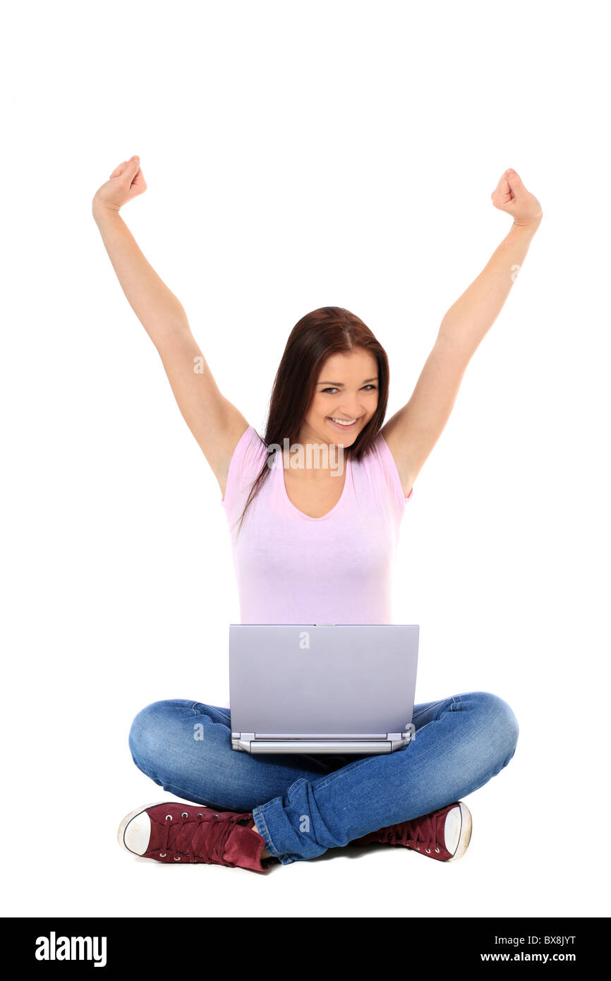 Attractive teenage girl cheering while using notebook computer. All on ...