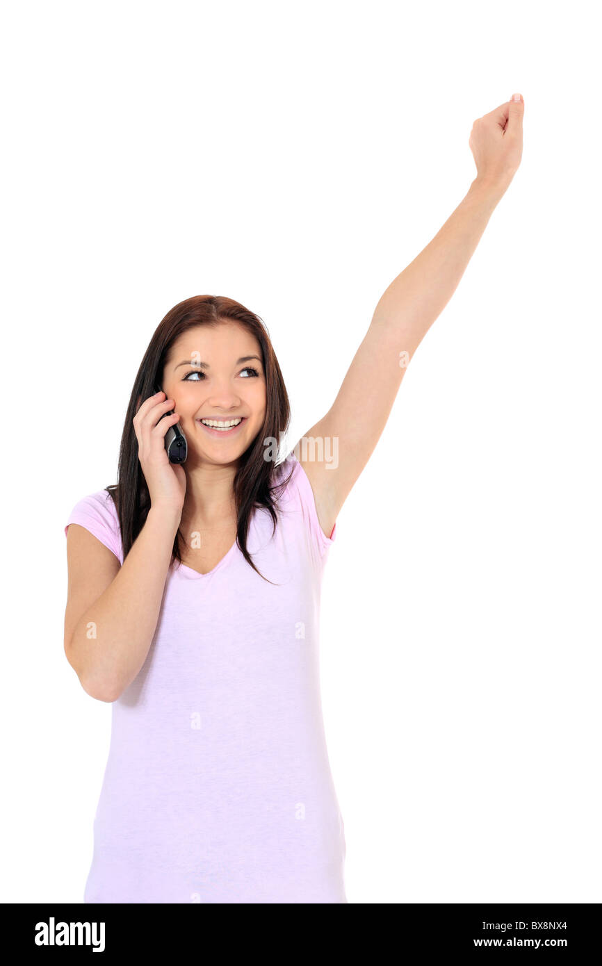 Attractive teenage girl cheering during phone call. All on white ...