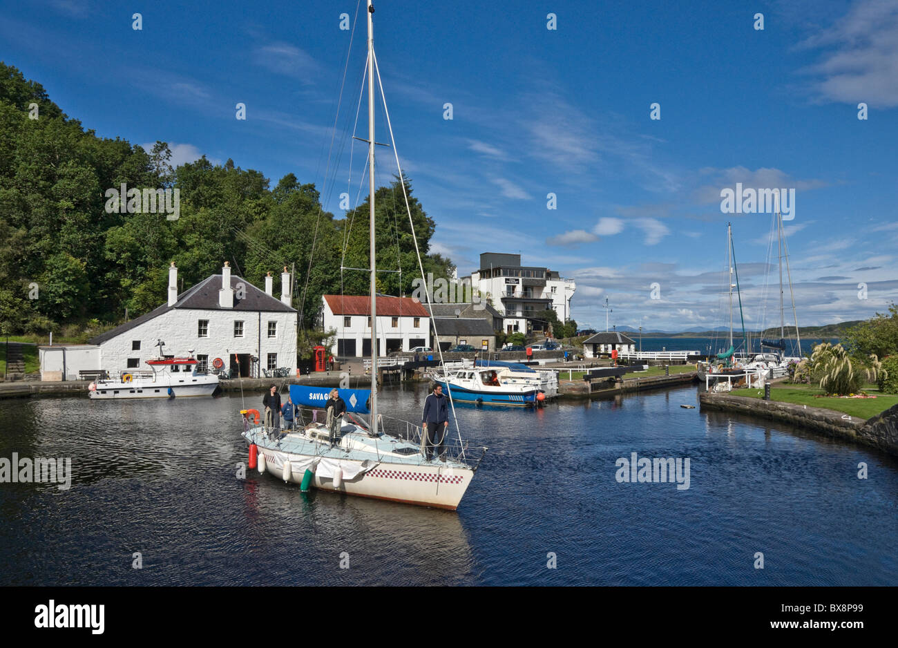 A yacht has entered the Crinan Canal basin at Crinan in Knapdale Argyll ...