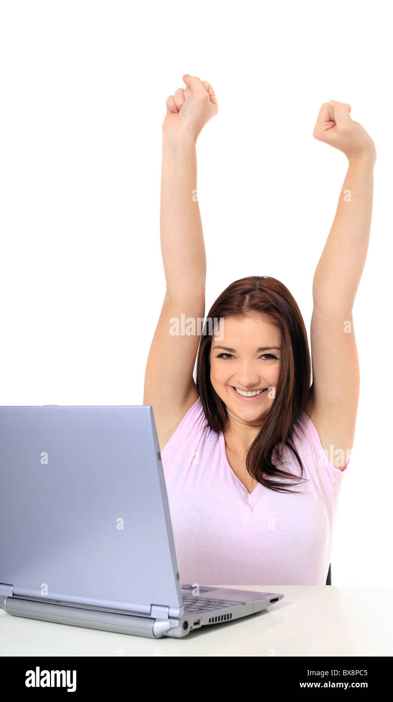 Attractive teenage girl cheering while using her notebook computer. All ...