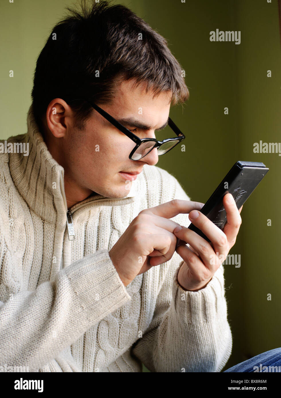 Cute nerd using calculator Stock Photo - Alamy