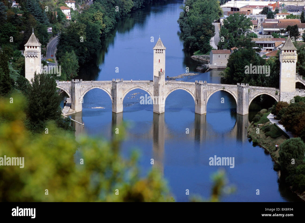The Pont Valentre, a 14th-century fortified stone arch bridge reflected ...