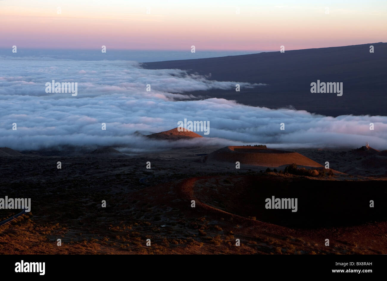 Sunset on Mauna Kea in Hawaii Big Island with old craters view lit by ...