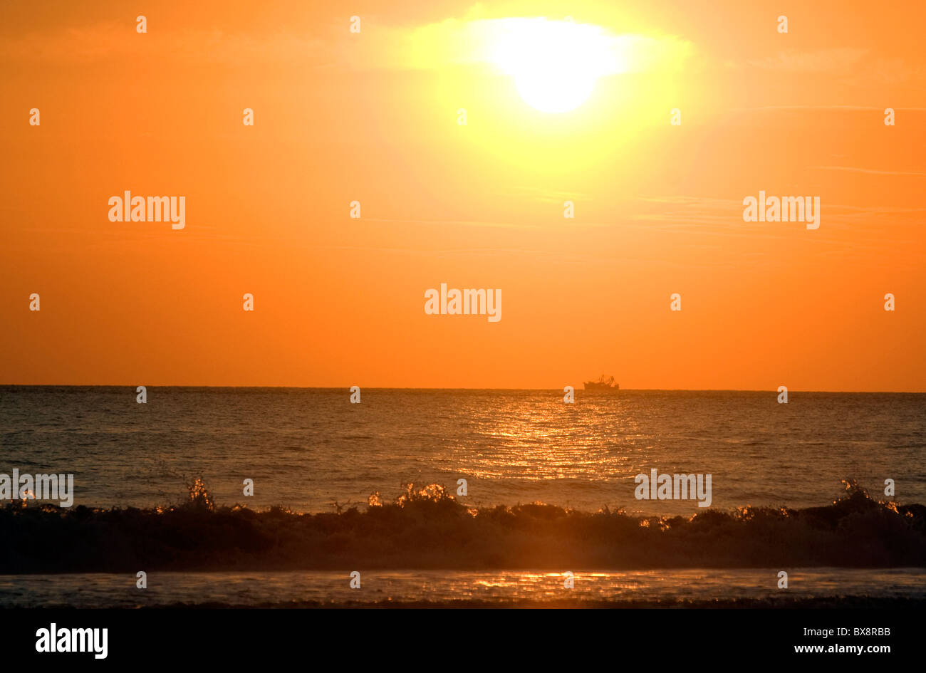 Fishing boat in the pacific ocean at sunset off the coast of Jaco ...