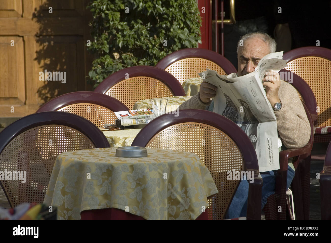 An Italian man reading newspaper in a restaurant surround Campo dei ...