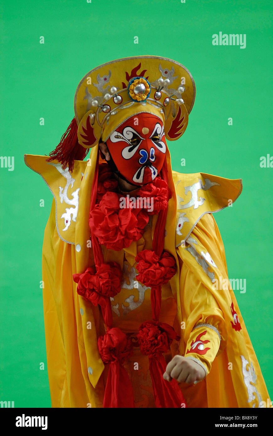 A performer wearing vividly colored mask and costume performing Bian ...