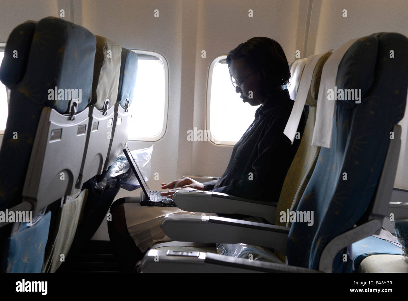 An African passenger using laptop computer inside an Ethiopian Airlines ...
