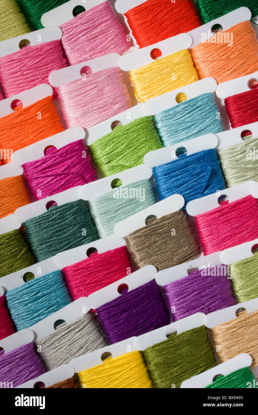 A selection of brightly coloured cotton threads on bobbins Stock Photo ...
