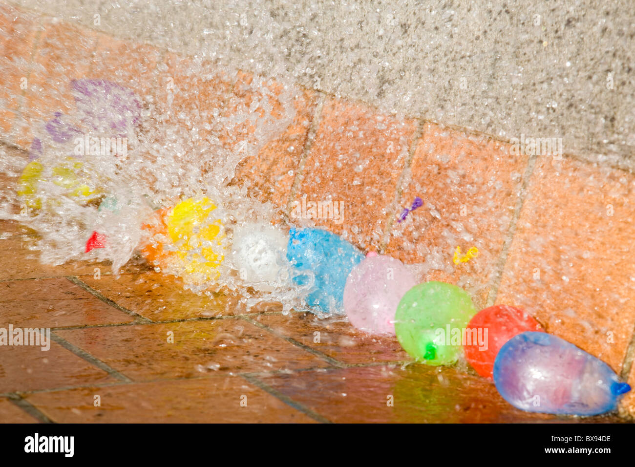 Water filled multicolored balloons explosion Stock Photo - Alamy