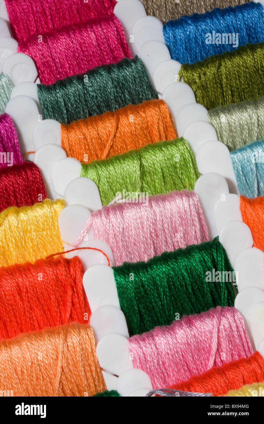 A selection of brightly coloured cotton threads on bobbins Stock Photo ...