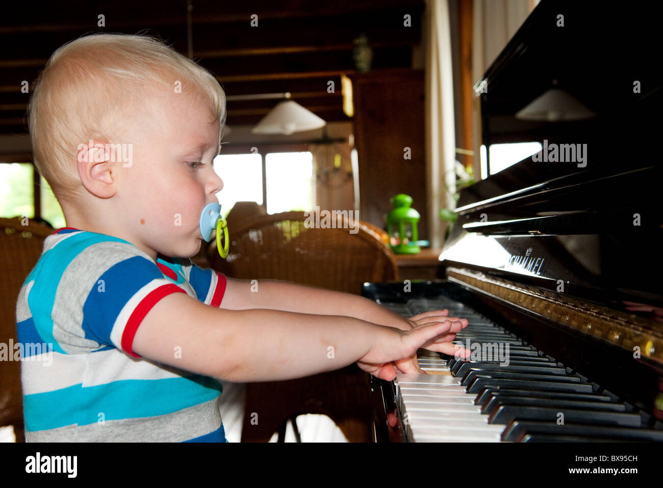 Very young child is playing the piano Stock Photo - Alamy