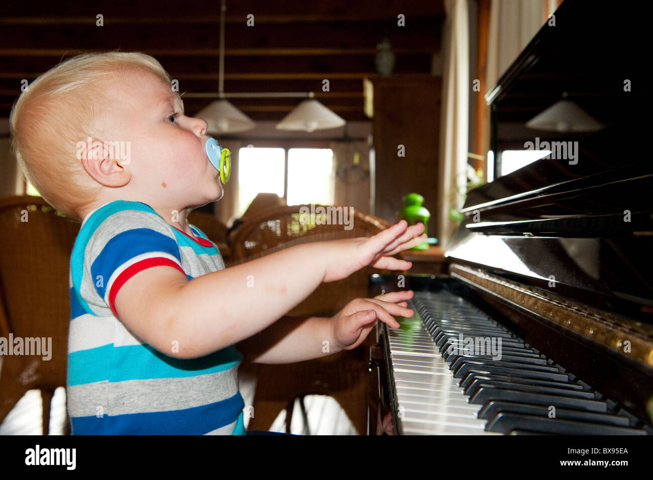 Very young child is playing the piano Stock Photo - Alamy