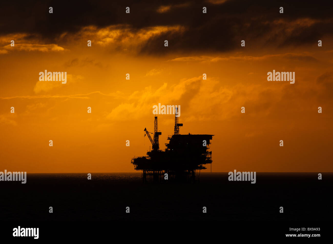 silhouette of an oil production rig during sunset Stock Photo - Alamy