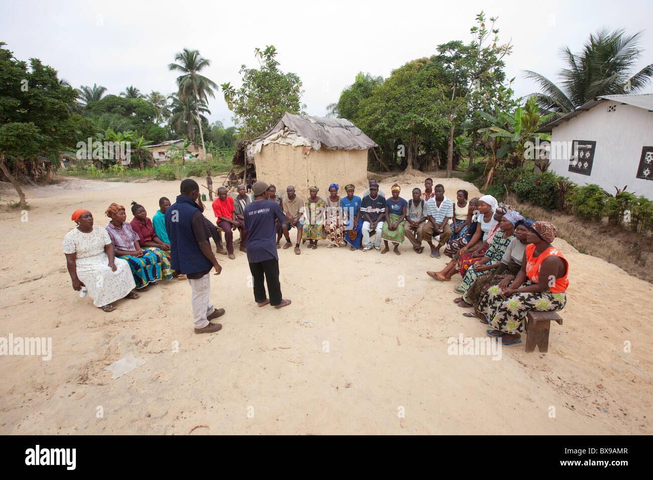 Villagers attend a community meeting in the town of Kakata, Liberia ...