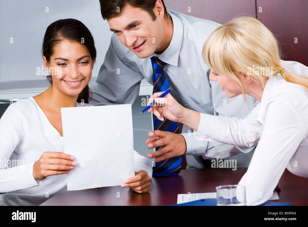 Portrait of three young people discussing their working plan Stock ...