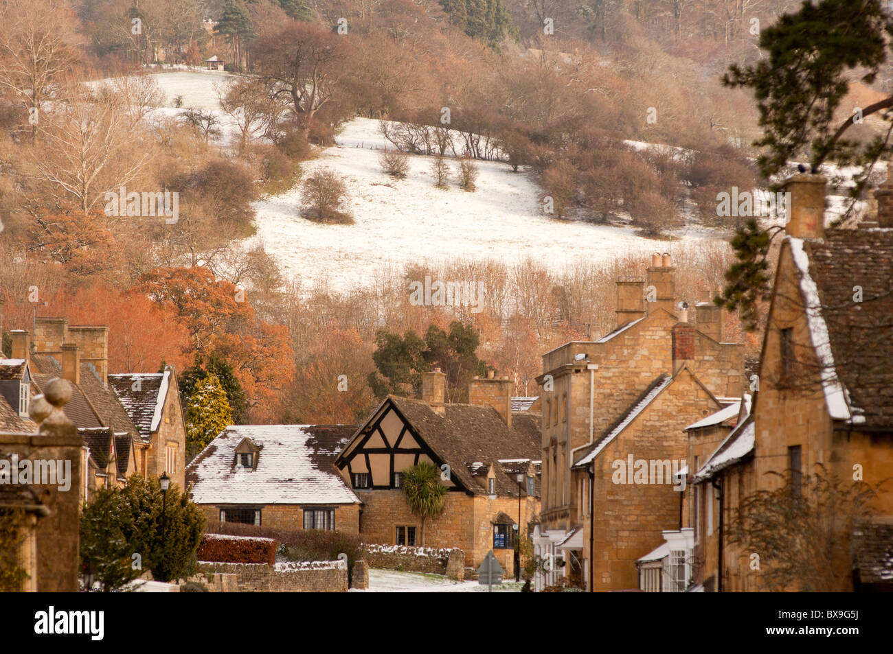 The Cotswolds village of Broadway with snow covered hills in the ...