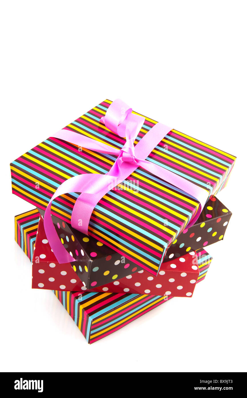 Many colorful stacked presents isolated over white Stock Photo - Alamy