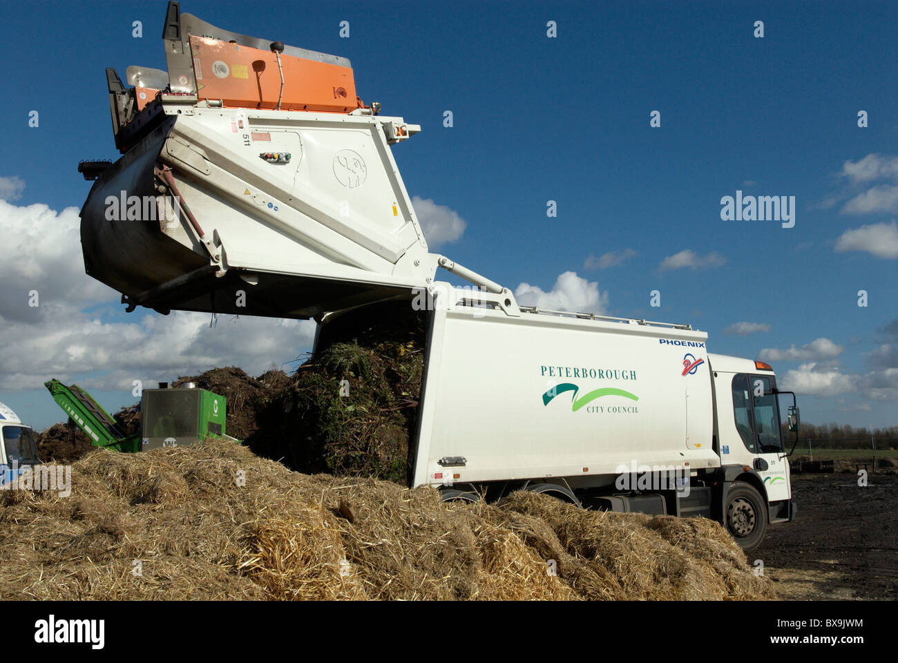 Truck unloading garden waste at site for recycling food and garden ...