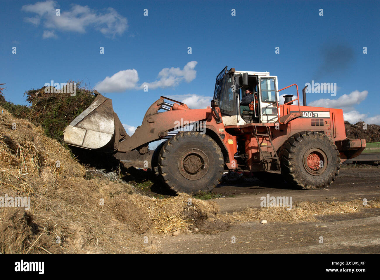 Tractor at site for recycling garden waste Suffolk UK Stock Photo - Alamy