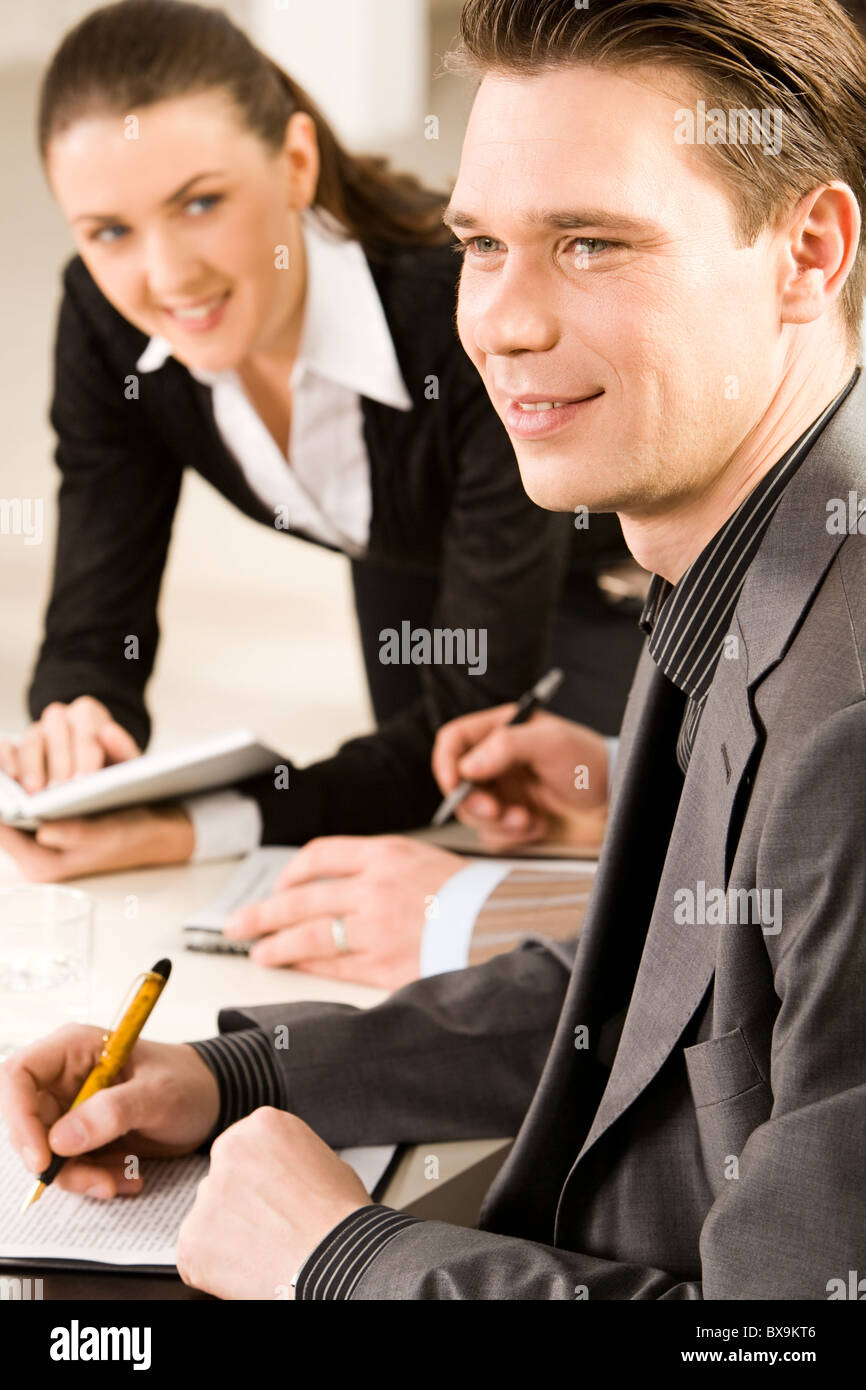 Portrait of thoughtful business man sitting at the table Stock Photo ...