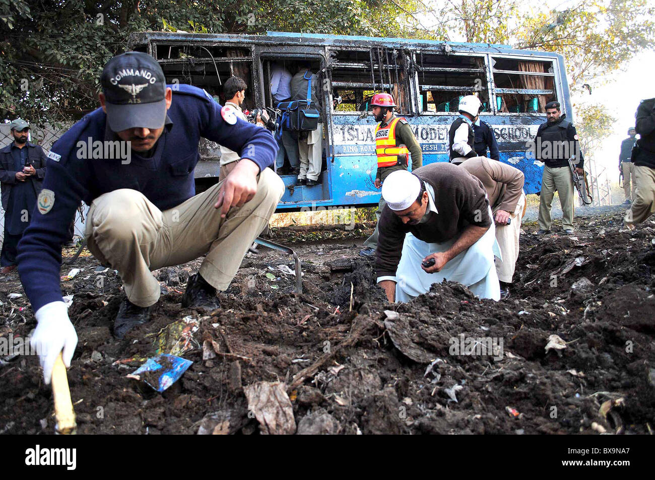 Security officials investigating the explosion site after a school bus ...