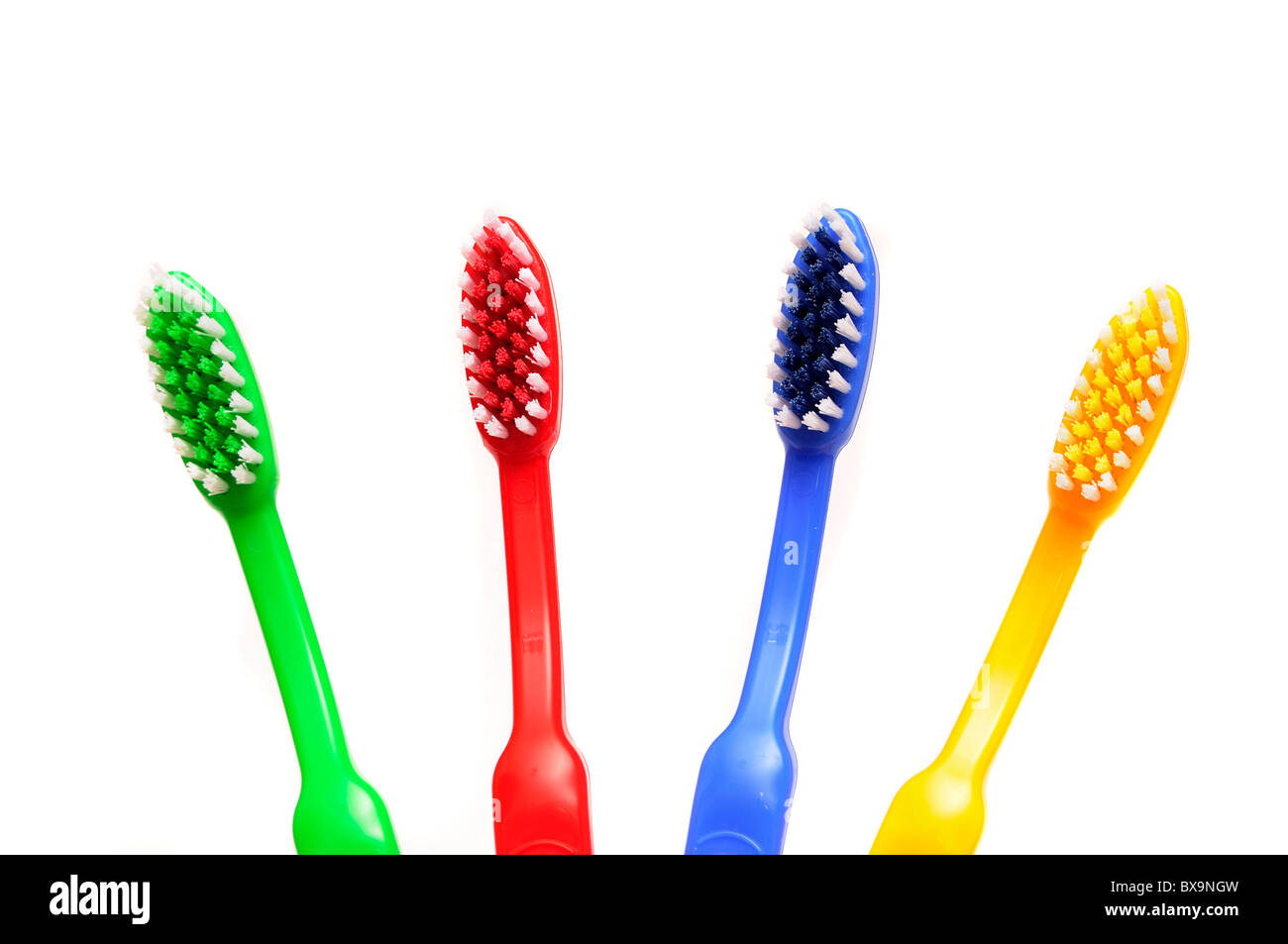 four colorful toothbrushes in a row Stock Photo - Alamy