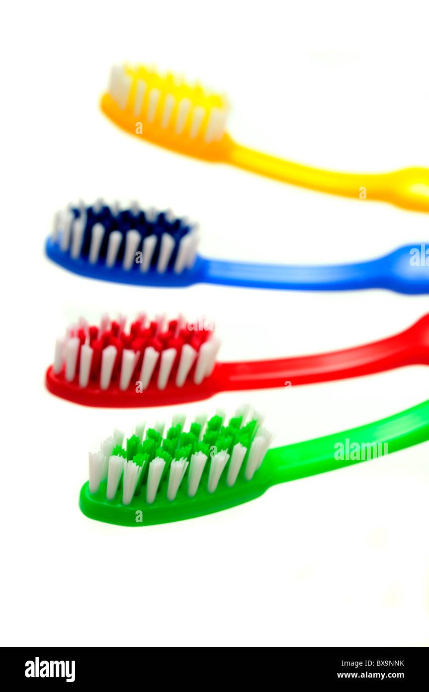 four colorful toothbrushes in a row Stock Photo - Alamy