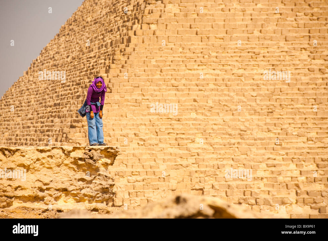 An Egyptian girl shares a laugh in front of the Pyramid of Khufu ...