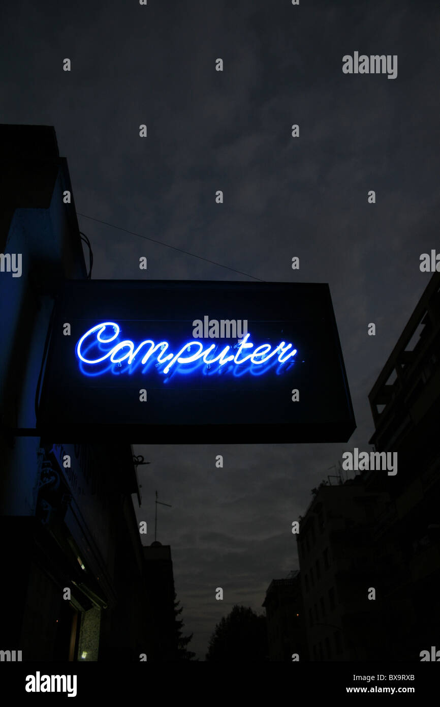 blue neon computer shop sign notice in city town Stock Photo - Alamy