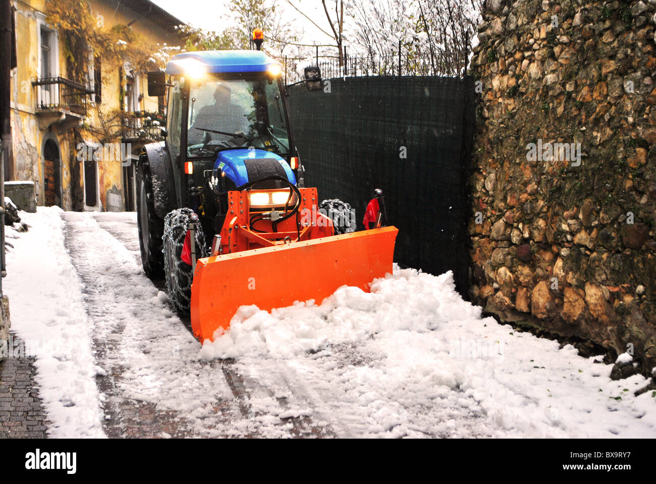 bulldozer shoveling snow in the Italian streets Stock Photo - Alamy