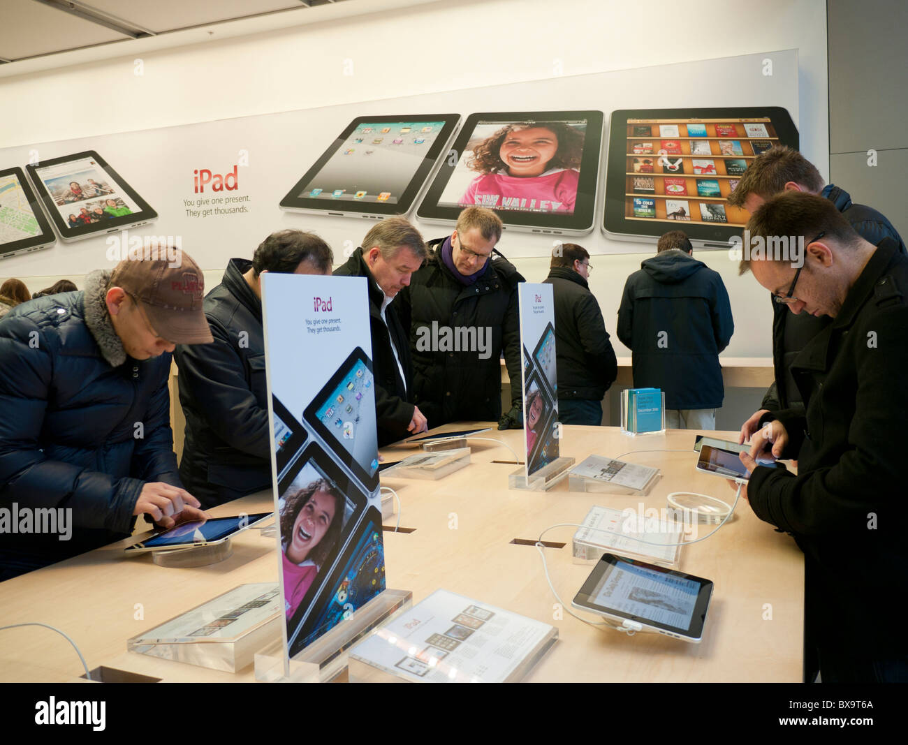 People looking at the Apple iPad on display in the Apple Store in ...