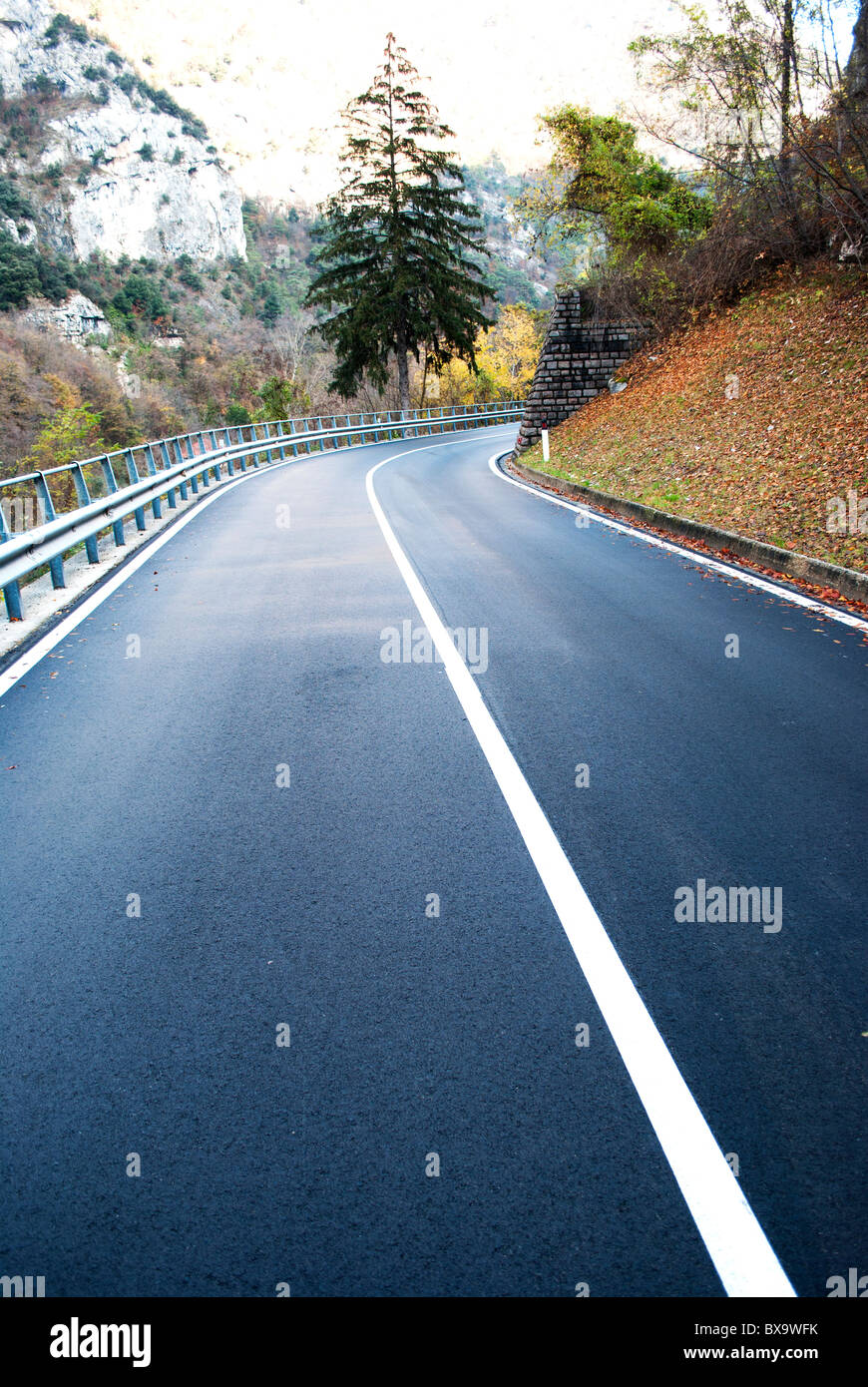 paved road with left turn Stock Photo - Alamy