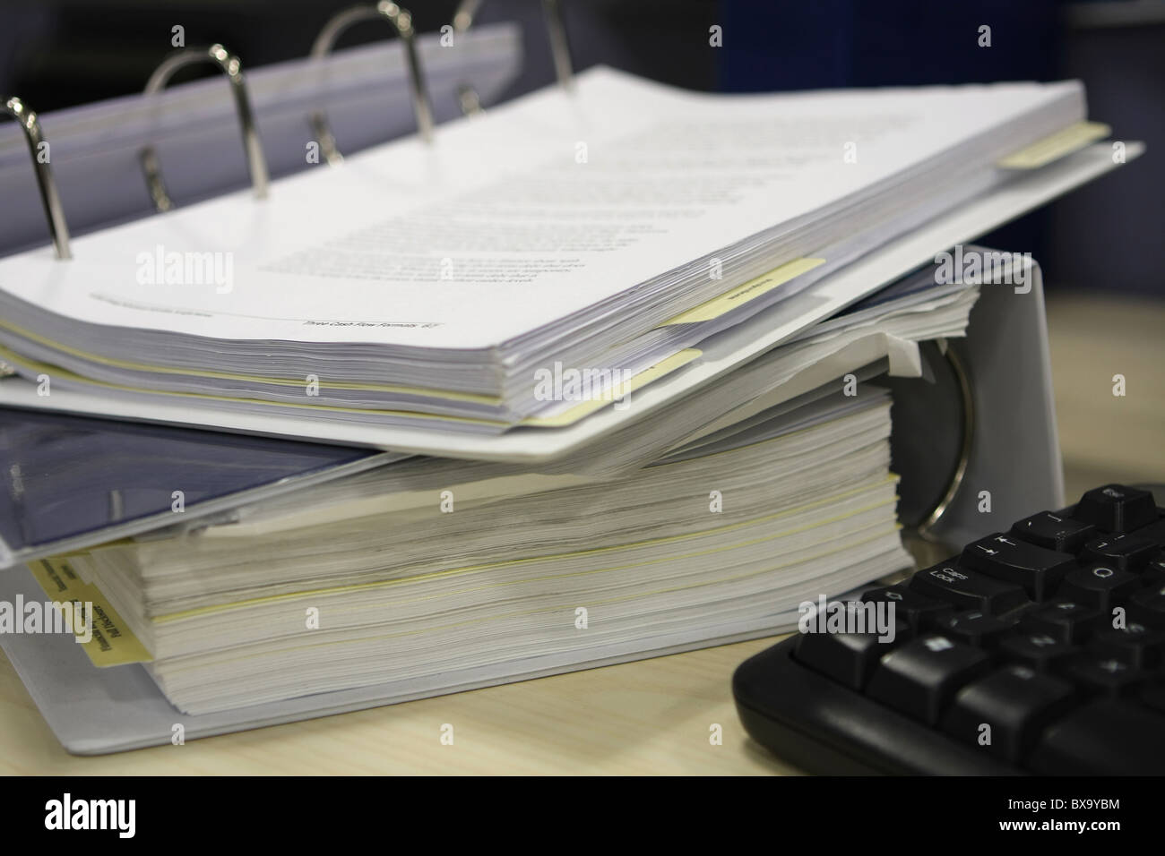A4 Folders Full Of Papers Next To Part Of A Computer Keyboard Stock
