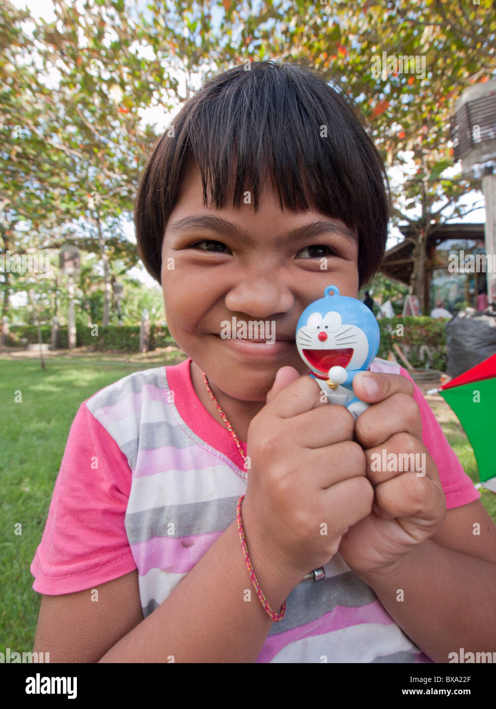 The girl showing her favorite cartoon character 'Doraemon' Stock Photo ...