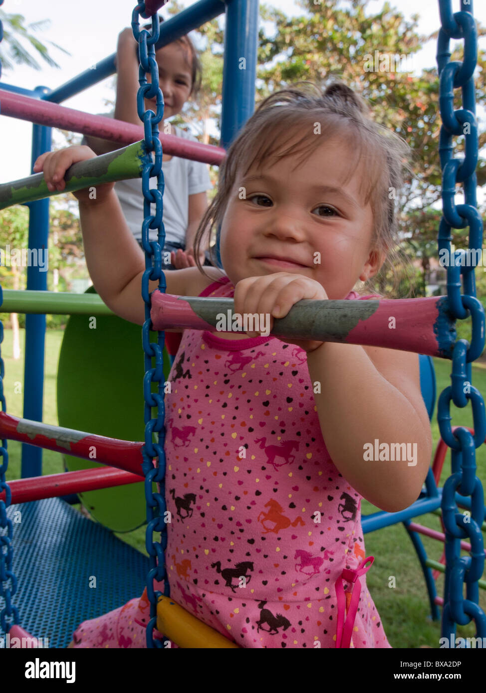 The girls enjoy playing climbing at the playground Stock Photo - Alamy