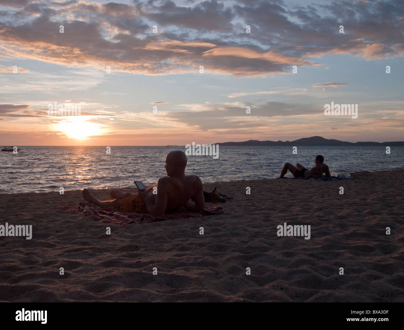 The two single young man enjoying sunset on the beach at Pattaya ...