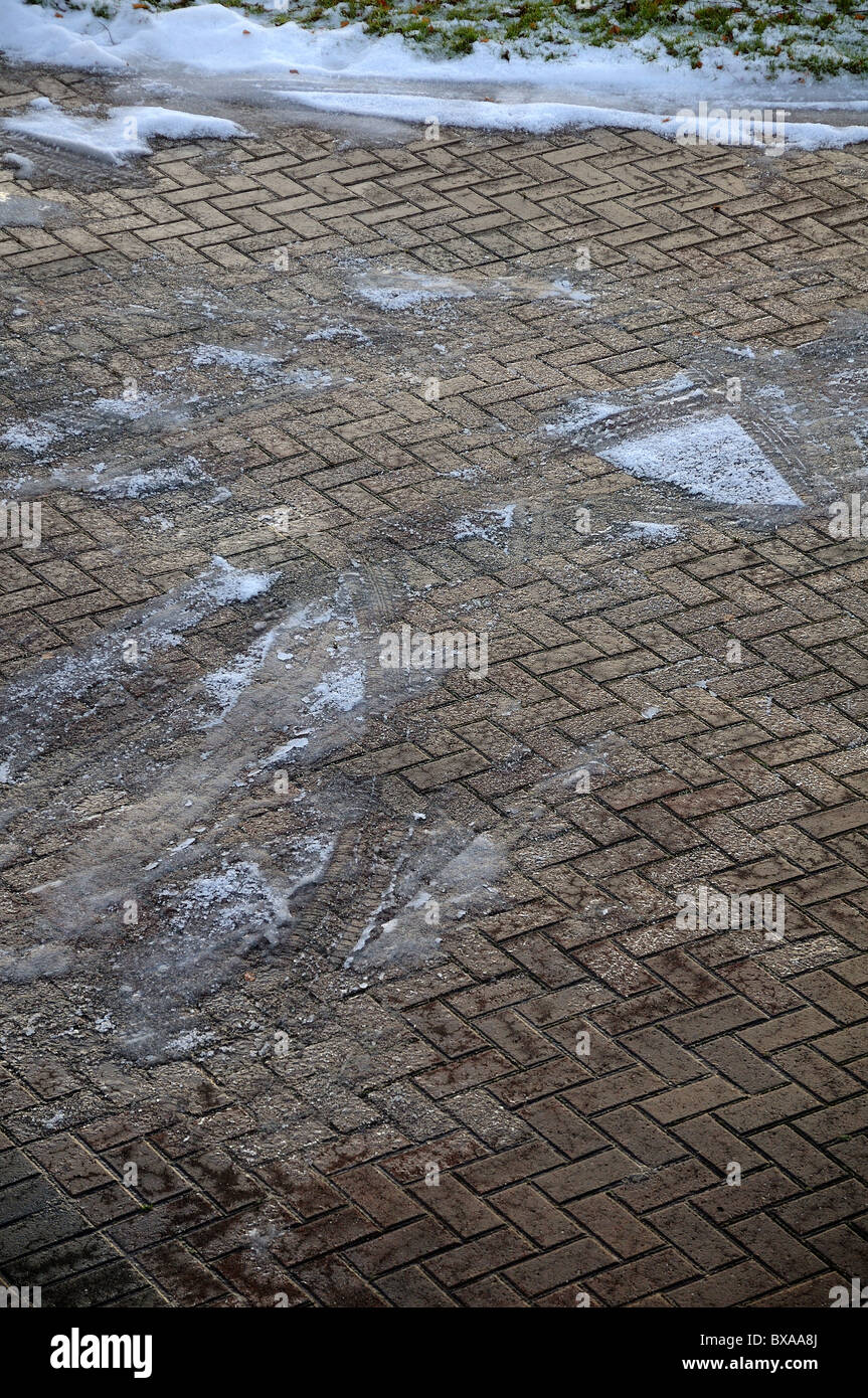 brick driveway with icy patches in winter Stock Photo - Alamy